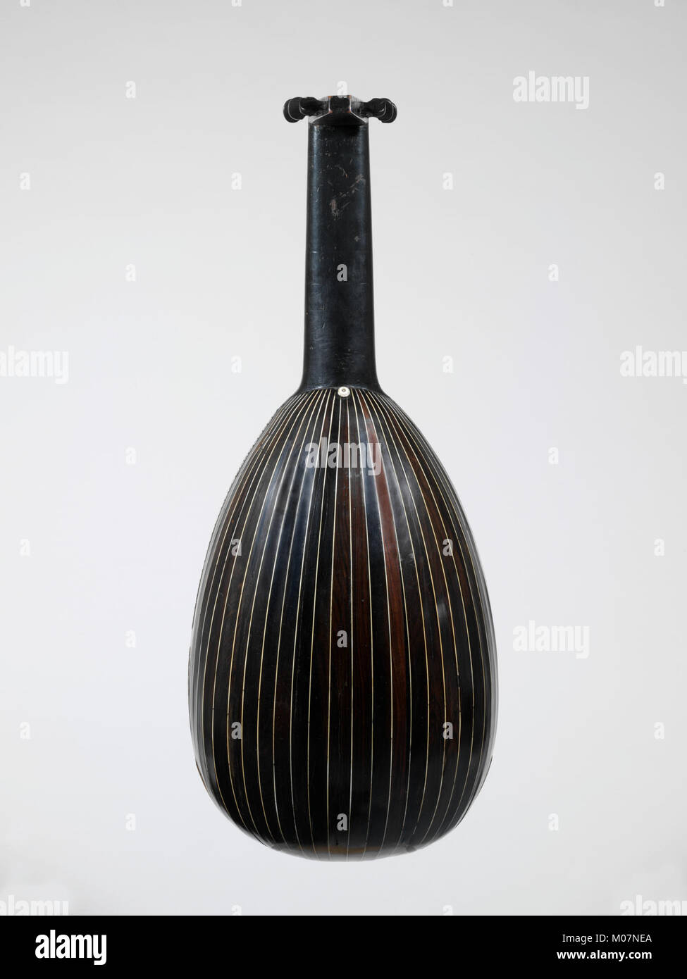 This lute, an early stringed instrument, features a distinct design ...