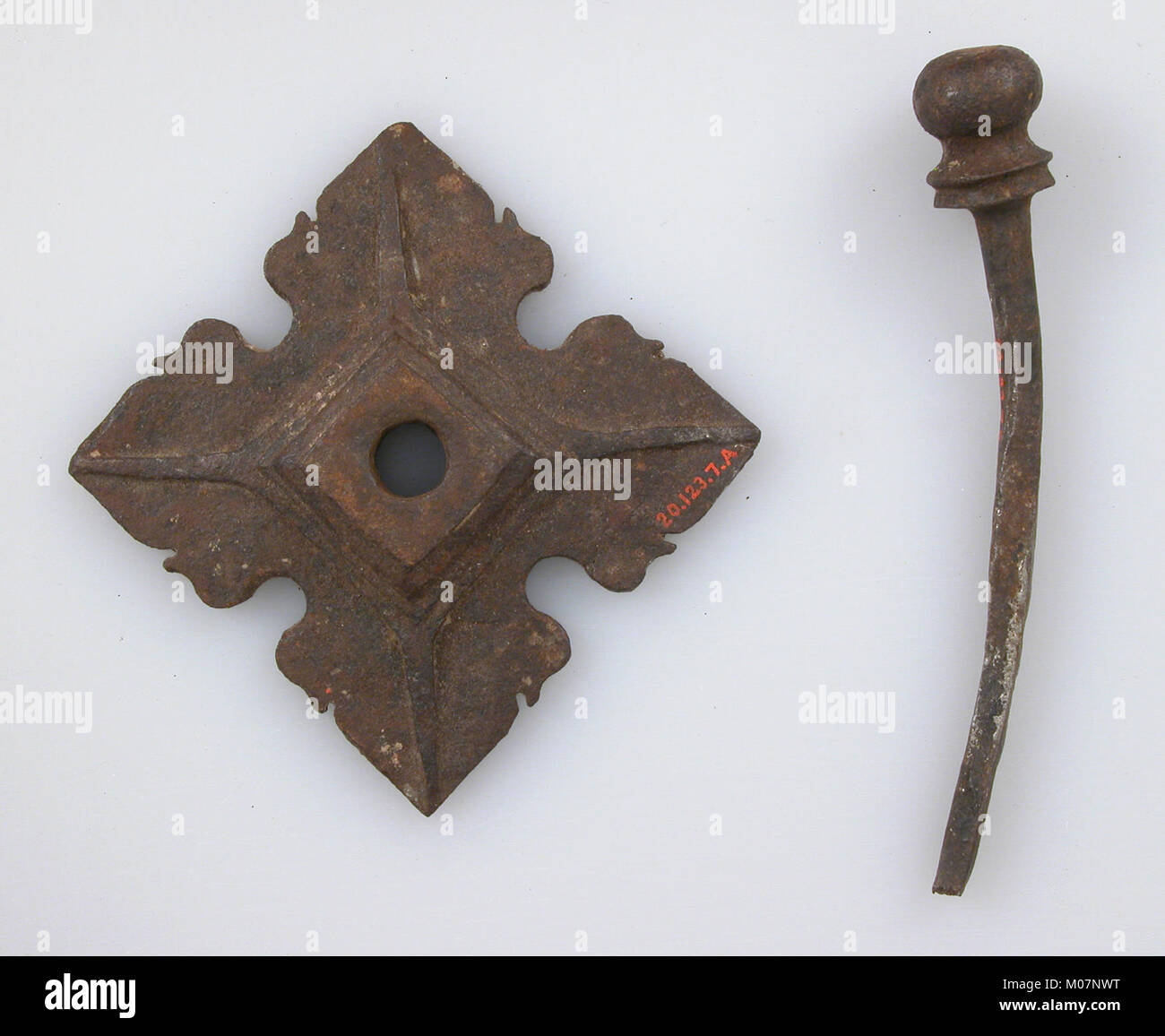 The nail head artifact represents a historical metalwork piece. Its ...