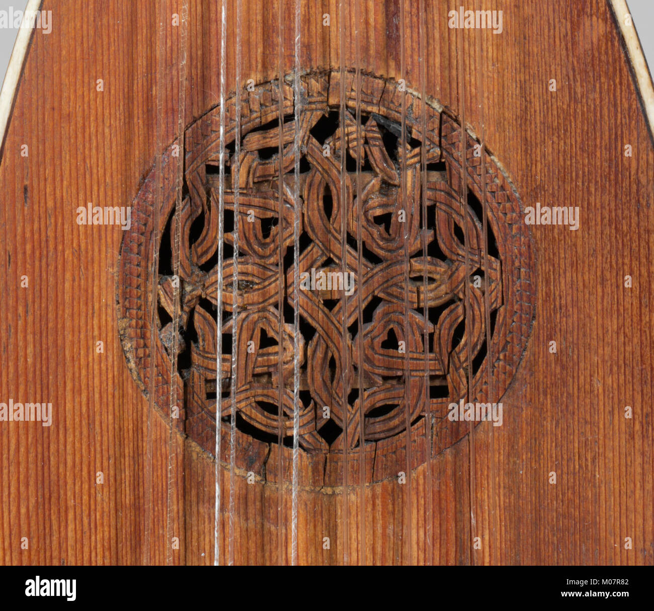This mandolin, crafted with fine wood and strings, represents 18th ...