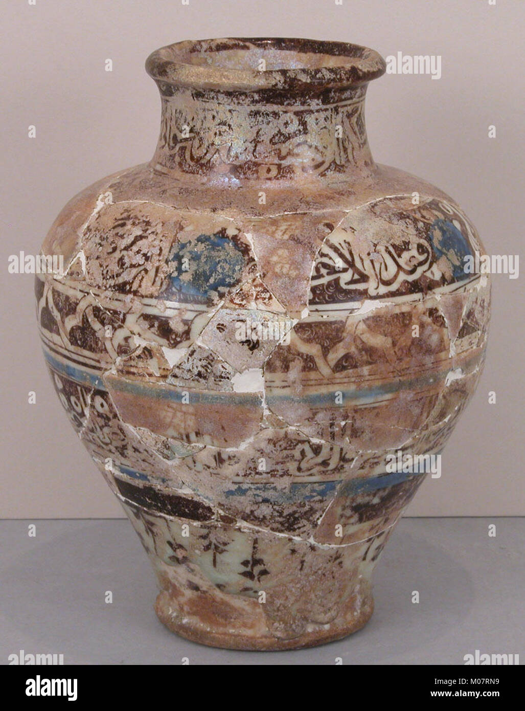 This jar from the MET collection has three inscribed cursive bands ...