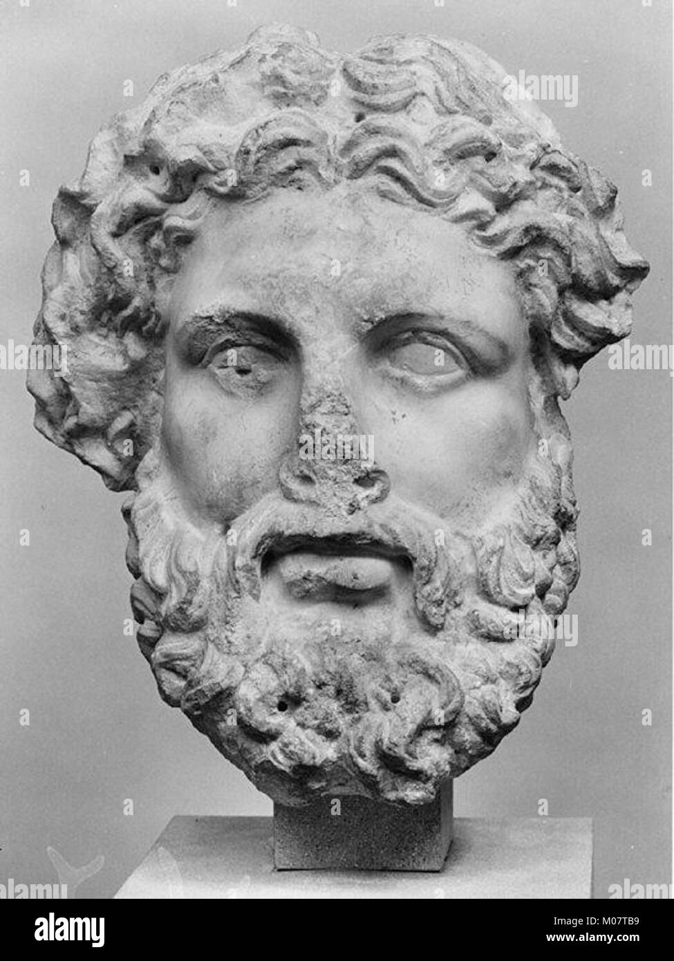 This marble head likely represents Zeus, the ancient Greek god. The ...