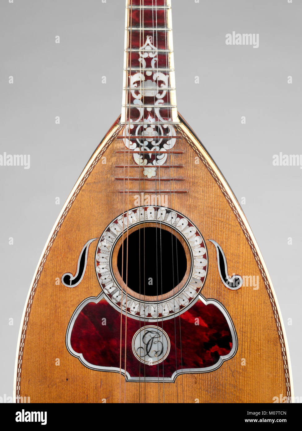 A mandolin, a stringed musical instrument, featuring a detailed design ...