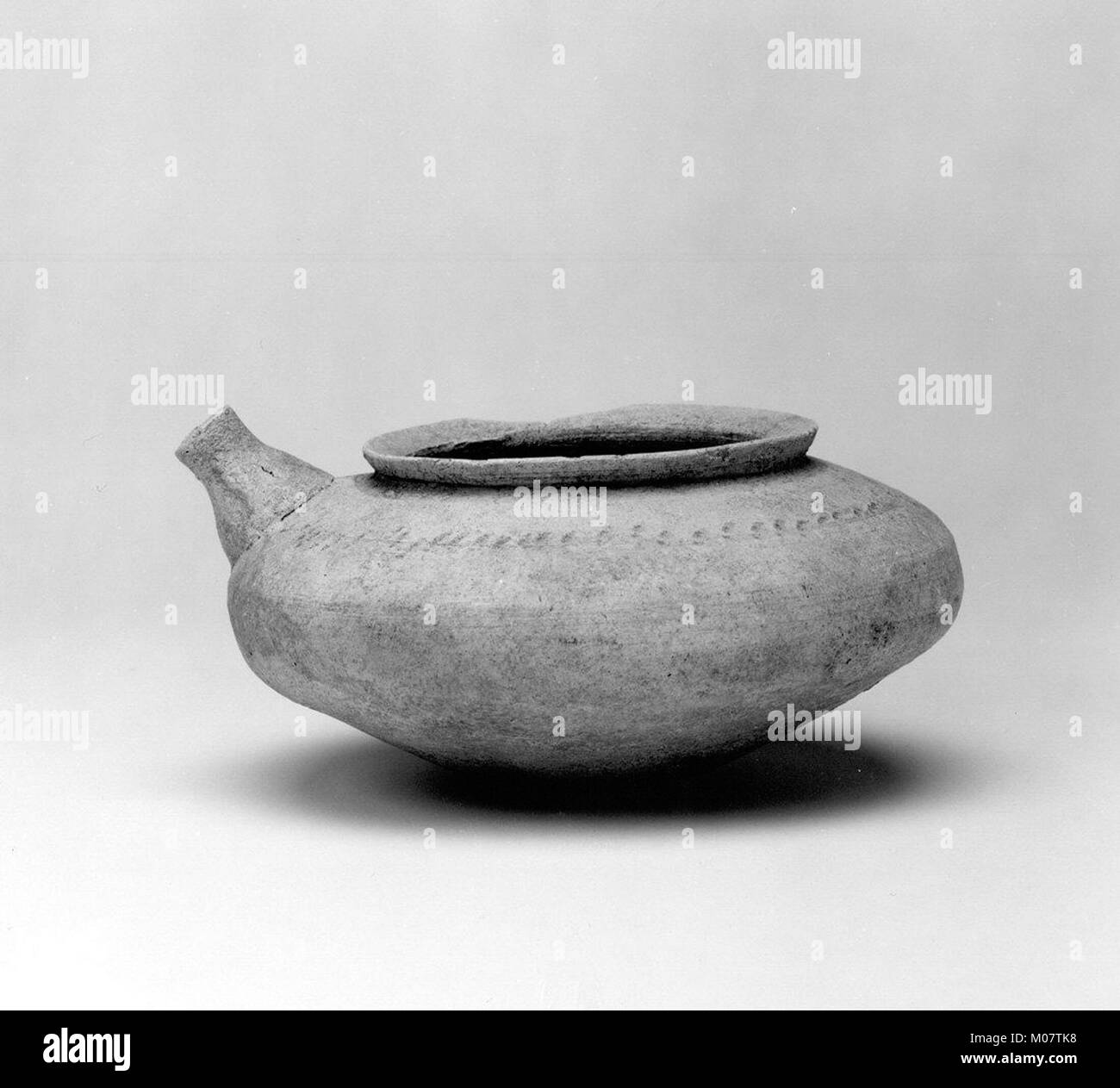 This jar, featuring a spout and punctate decoration, showcases the ...