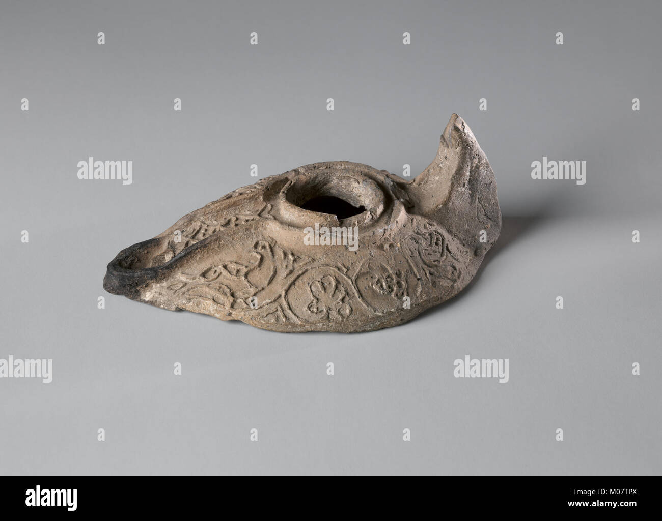 This lamp is a notable example of ancient lighting technology. Its ...