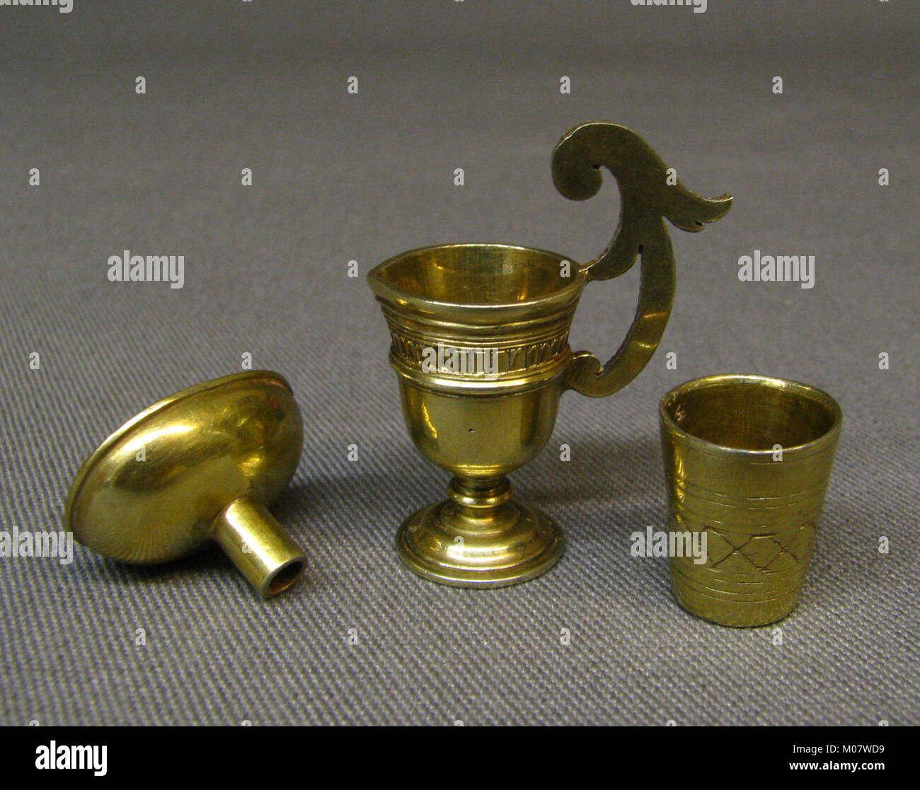 This miniature beaker features delicate craftsmanship, typical of the ...