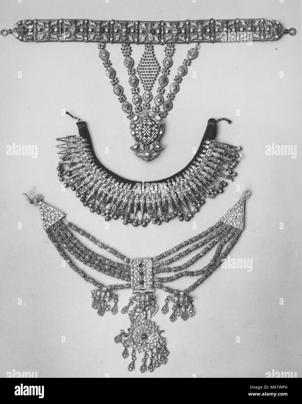 A necklace made from precious materials such as metal, beads, or ...