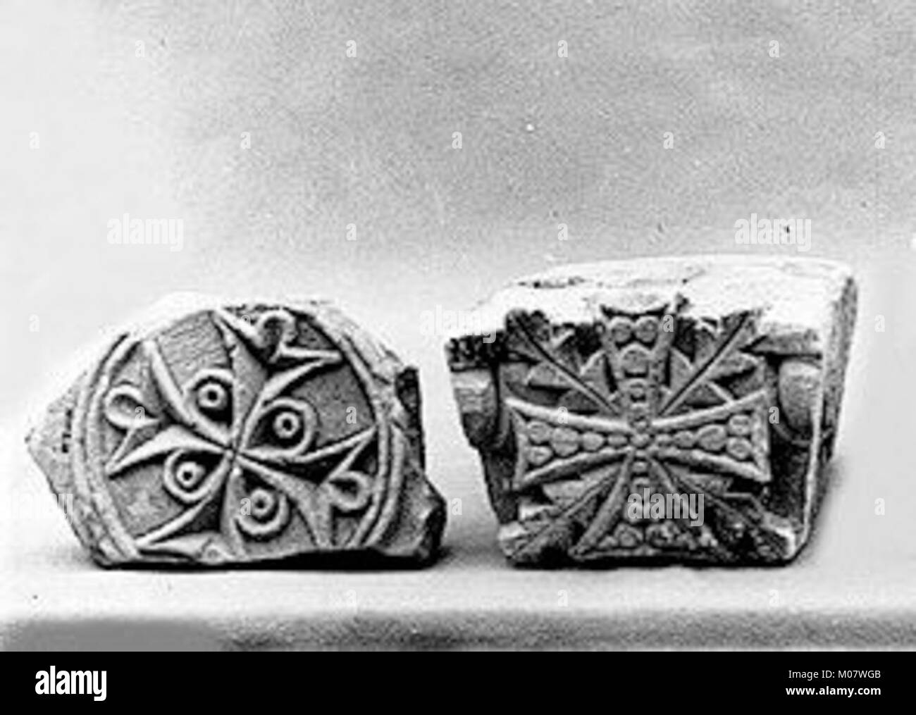 This architectural keystone features a cross and acanthus leaves ...