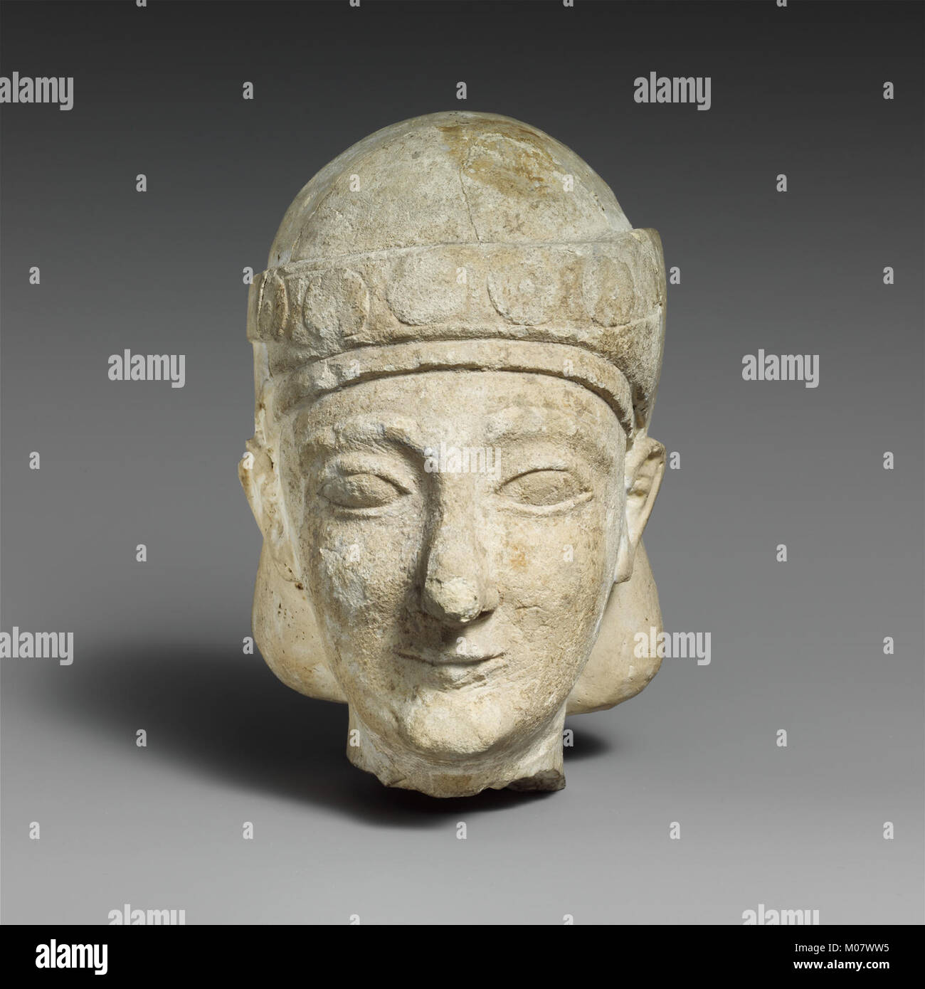 This limestone sculpture depicts a beardless male figure wearing a ...