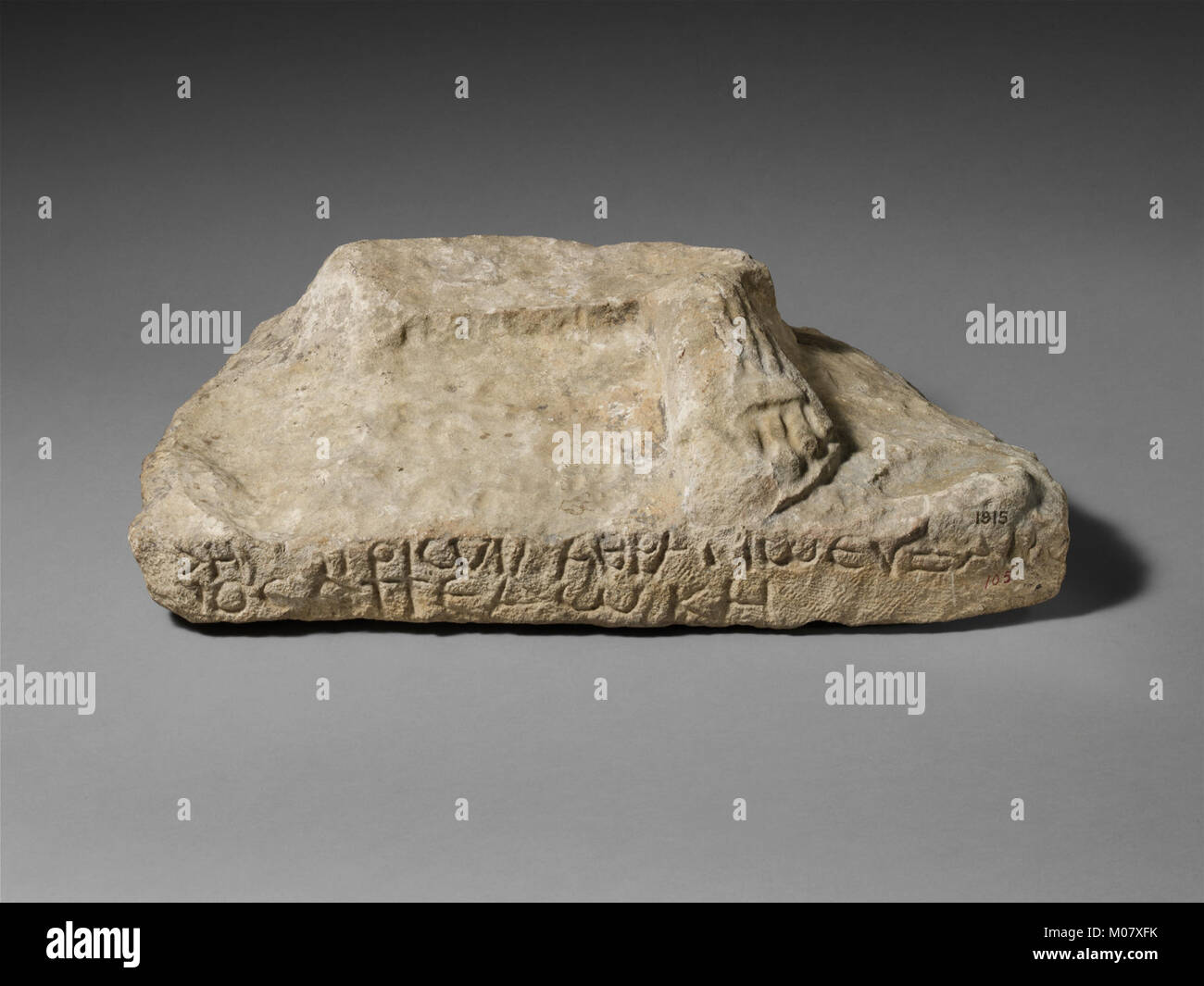 This limestone plinth features the left foot of a statue of Zeus ...