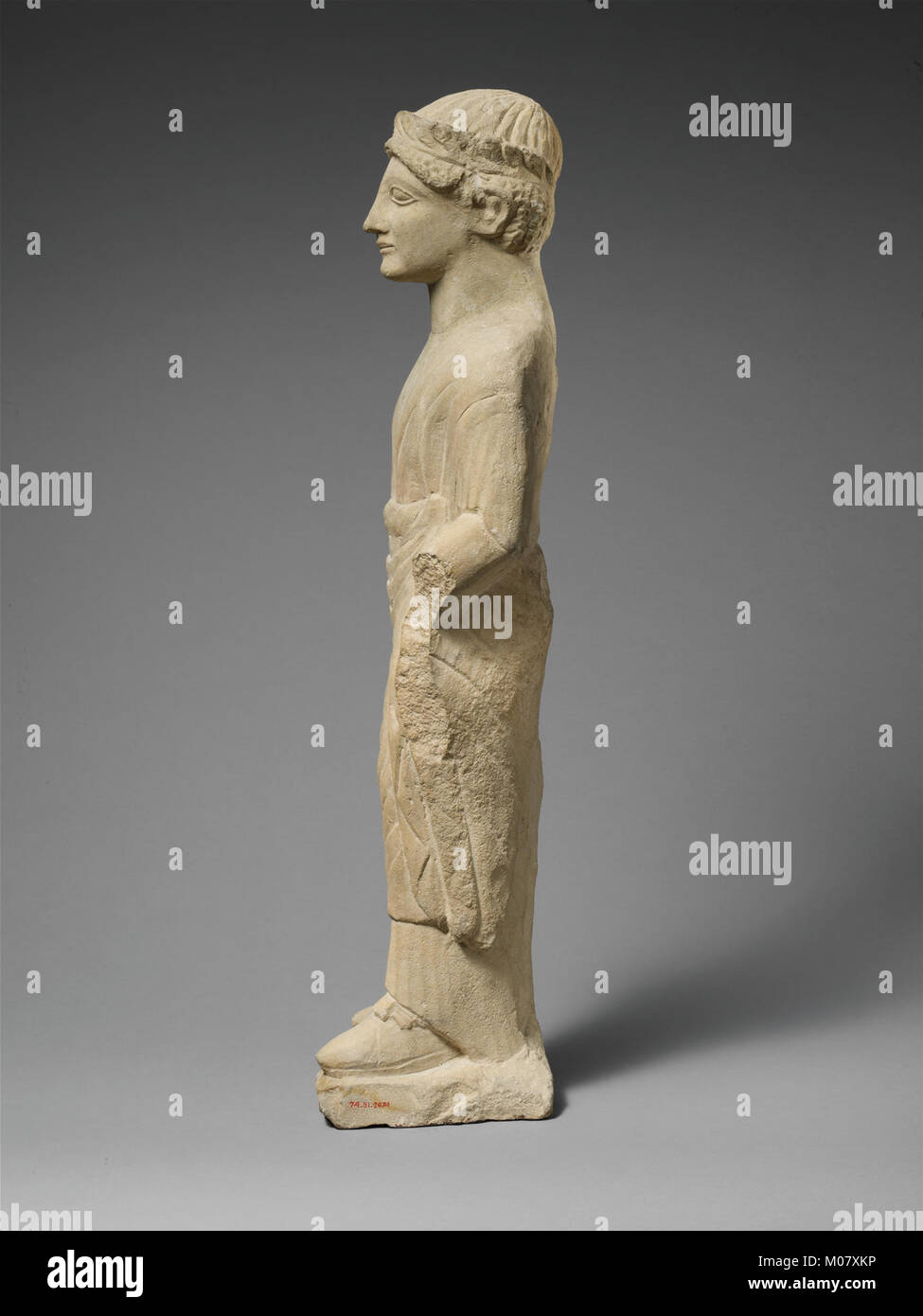 This limestone statuette depicts a beardless male votary wearing a ...