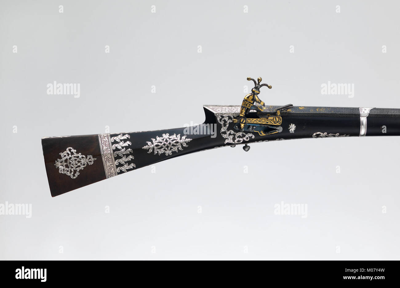 This Miquelet rifle, characterized by its distinctive lock mechanism ...