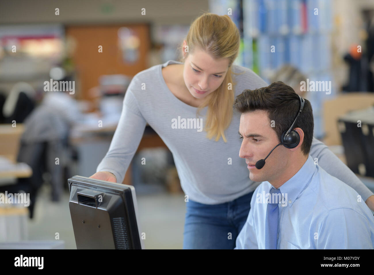 call centre workers looking at computer screen Stock Photo - Alamy