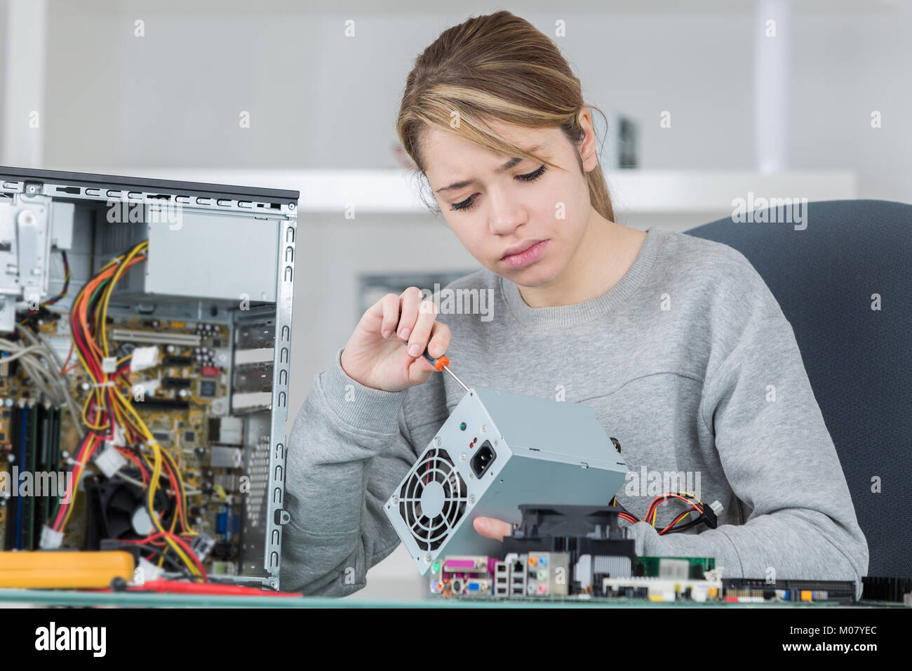 young woman fixing computer Stock Photo - Alamy