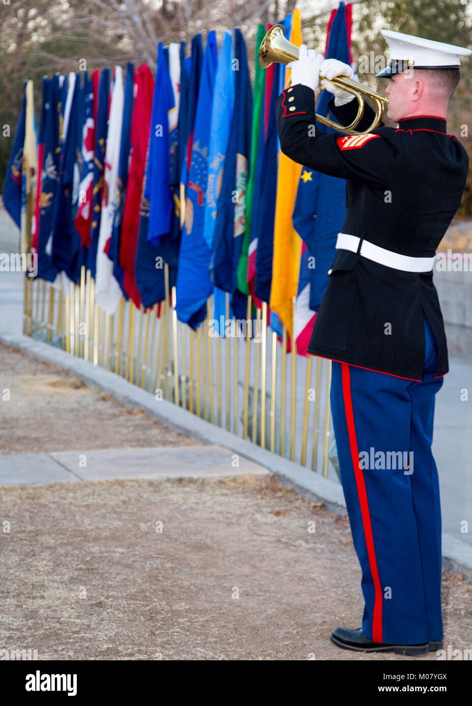 Sergeant Robert Taylor, wireman, performs evening colors in front of ...