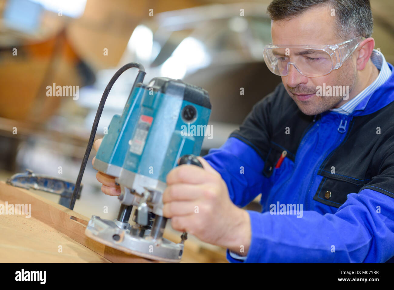 Tradesman using router Stock Photo - Alamy