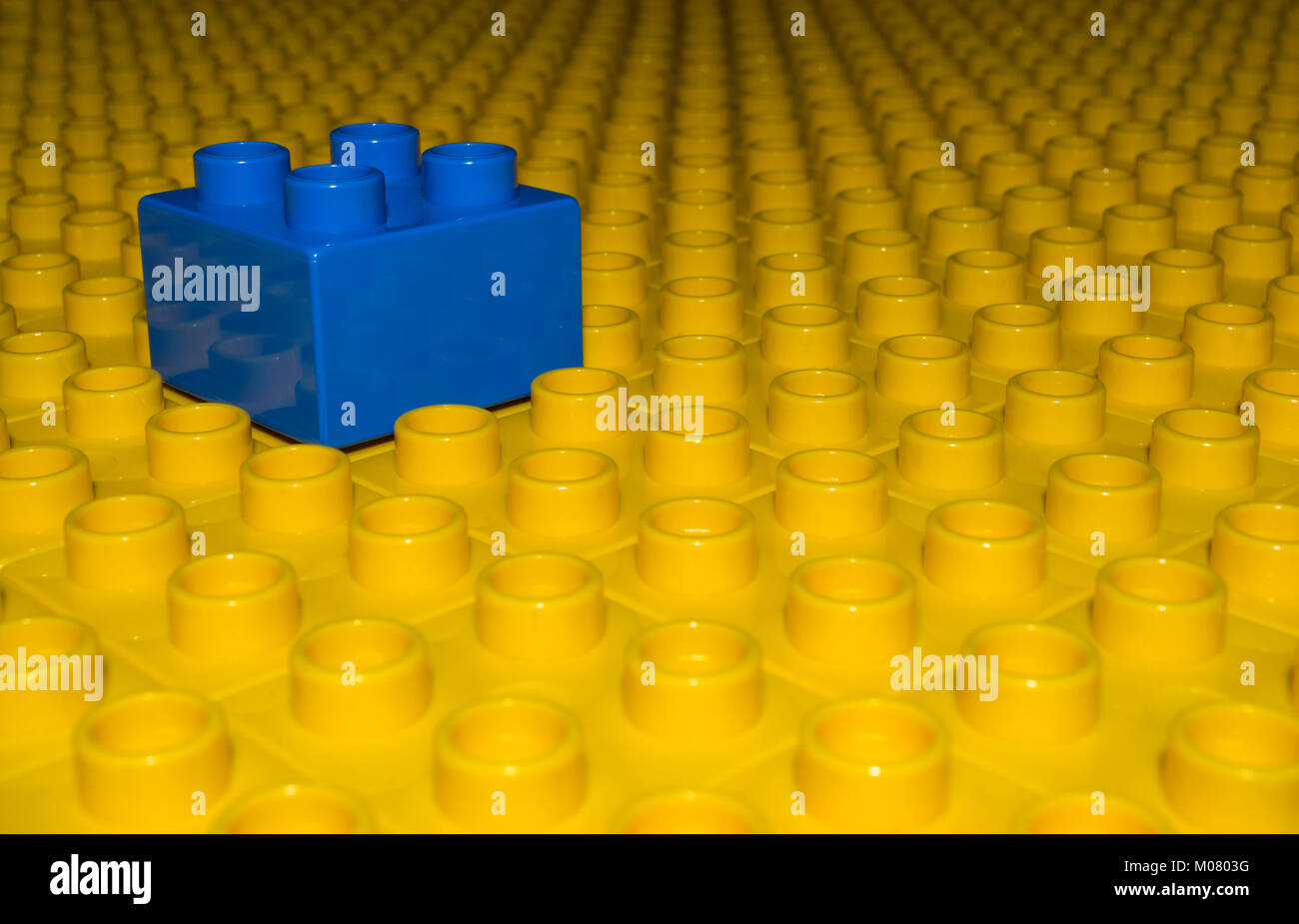 A sea of yellow building bricks all ligned up as far as they eye can ...