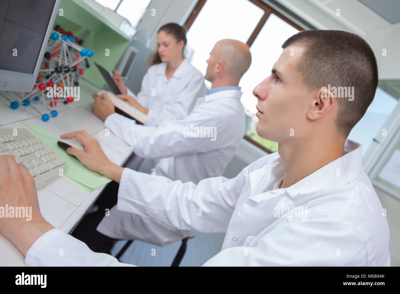 young man working at the medical laboratory using computer Stock Photo ...