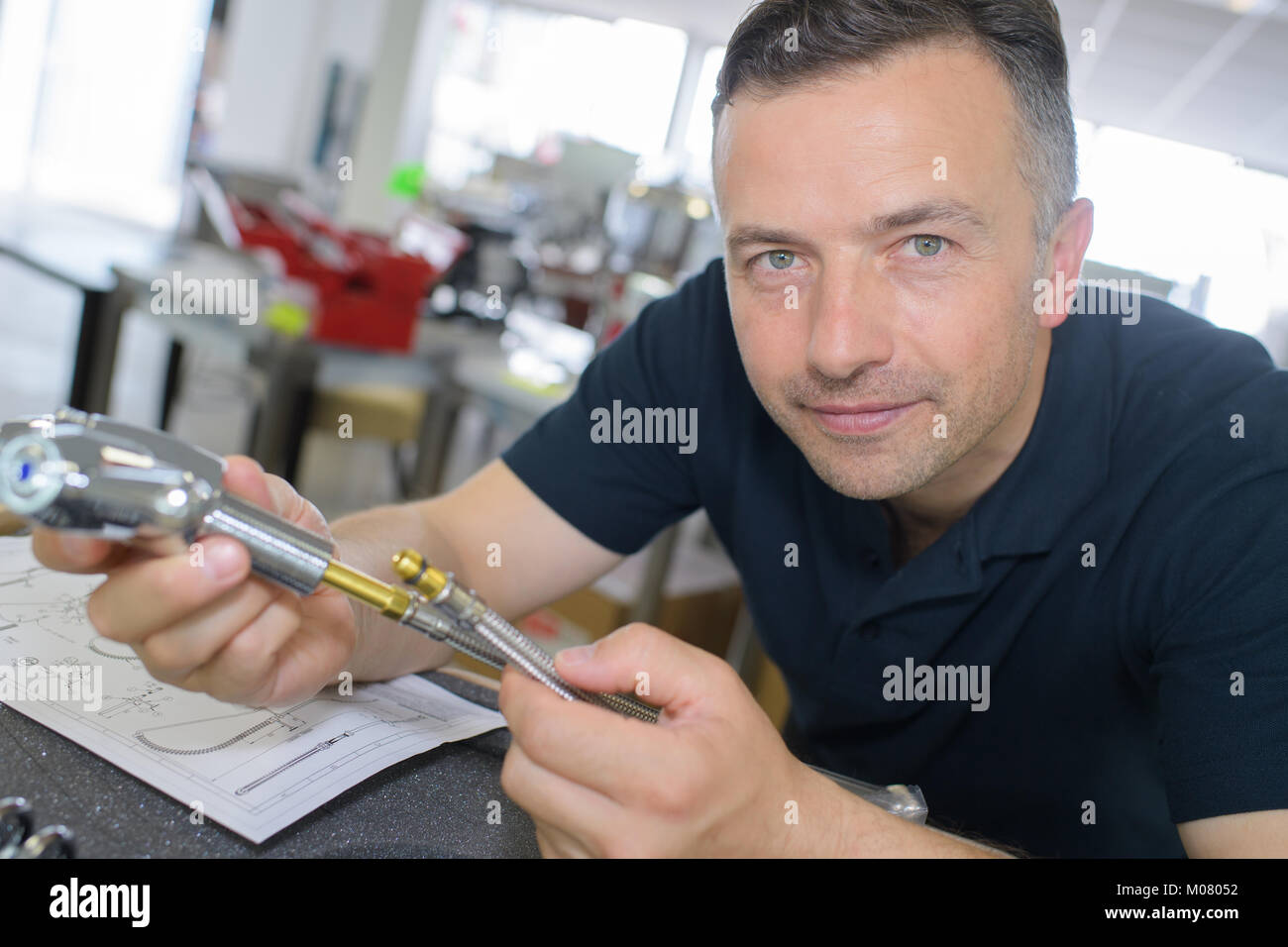 man working on electrical device Stock Photo - Alamy