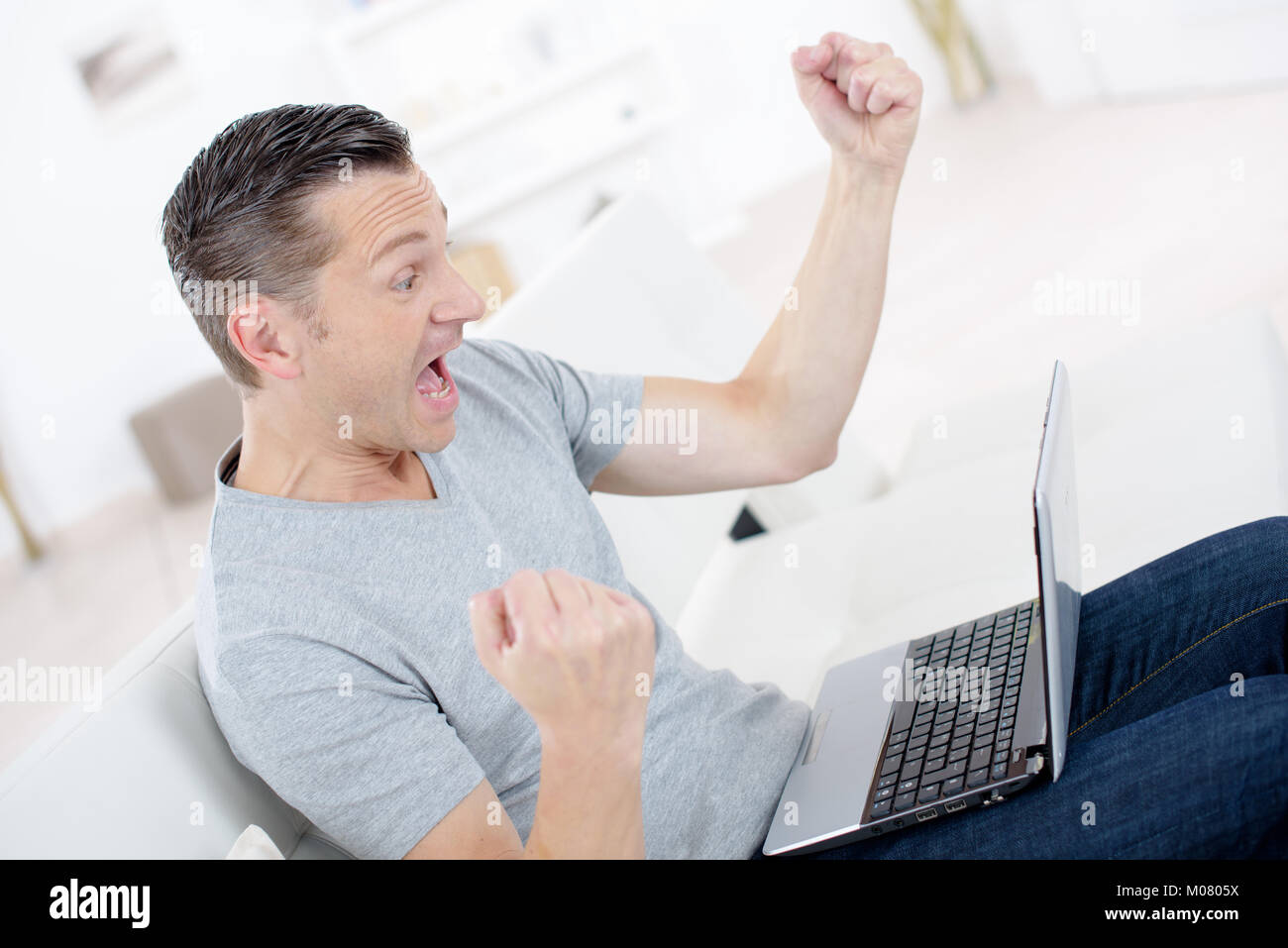 excited man with laptop Stock Photo - Alamy