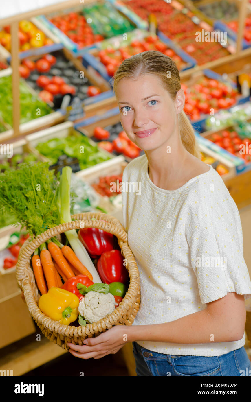 Woman with a basket of vegetables Stock Photo - Alamy