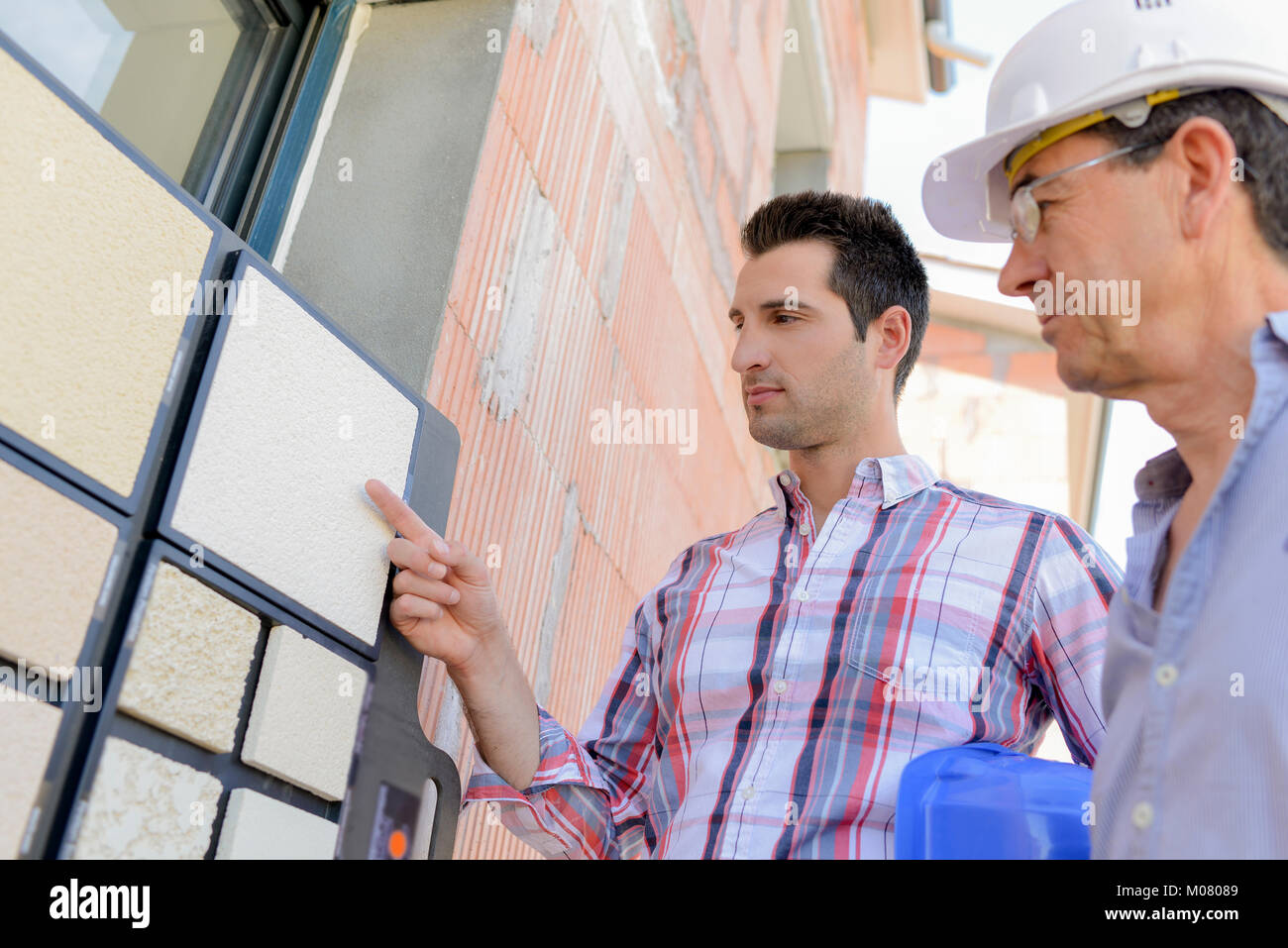 Going through options with foreman Stock Photo - Alamy