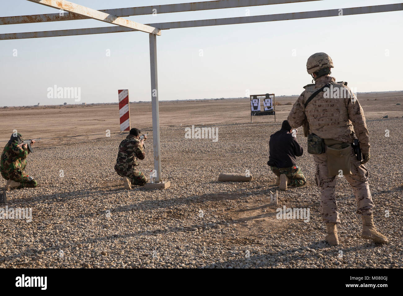 A Spanish soldier observes Iraqi soldiers during AK47 live fire ...