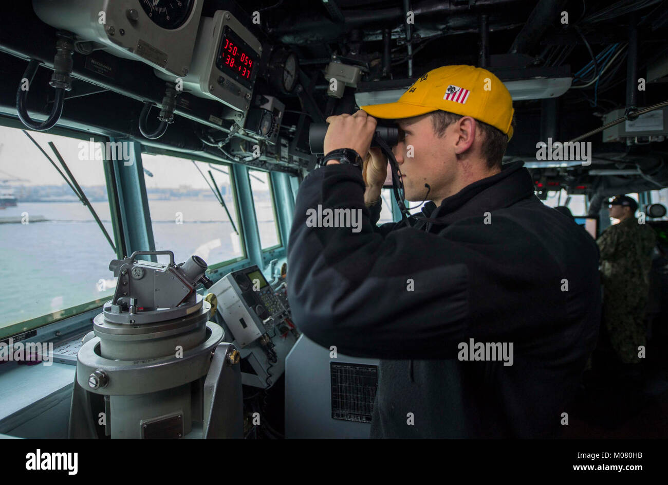 Ukraine (Jan. 8, 2018) Ensign Stephen Coles looks through binoculars ...