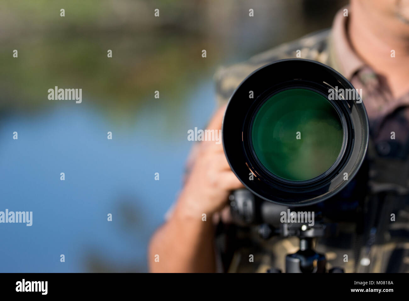 Photographer holding camera Stock Photo - Alamy