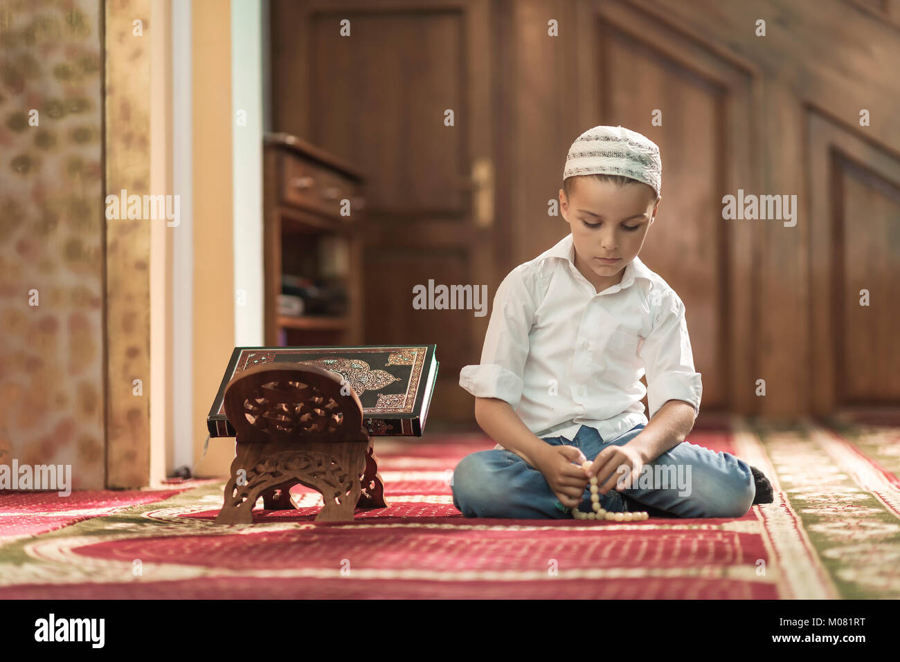 Ramadan Kareem,beautiful boy Muslim is praying in mosque,Peace and love ...