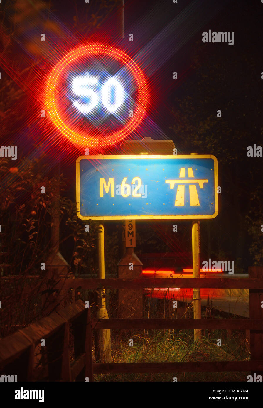 reduced 50mph speed limit warning sign on the M62 motorway at night ...