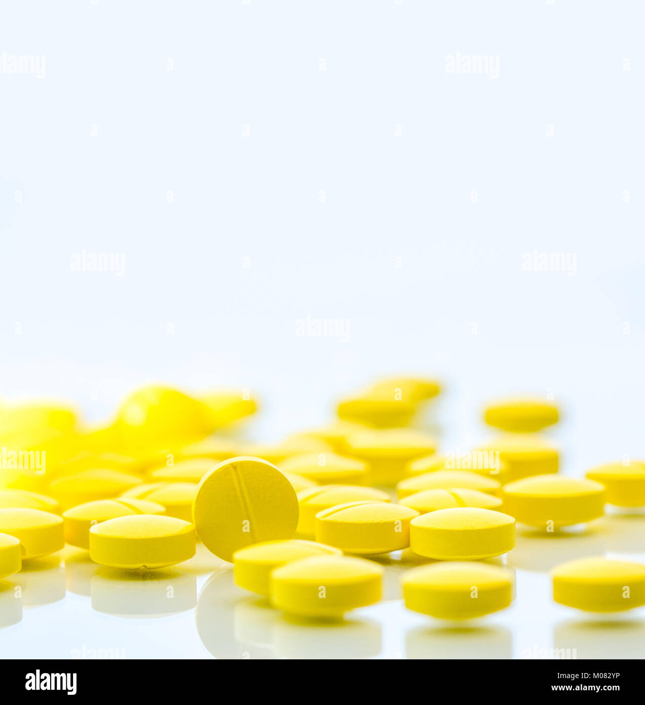 Yellow tablets pills isolated on white background with copy space. Pile ...