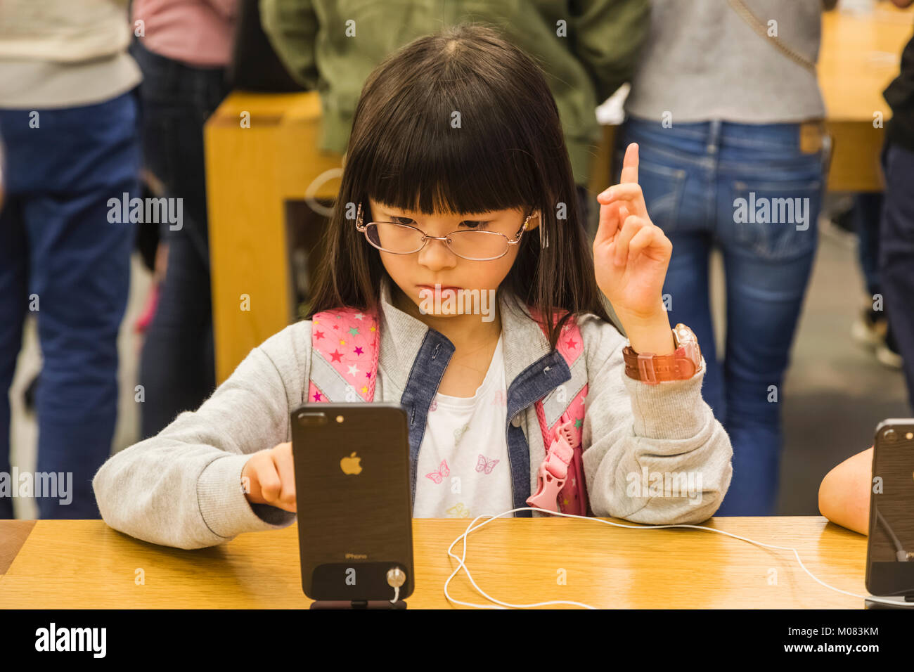 Children playing iphones hi-res stock photography and images - Alamy