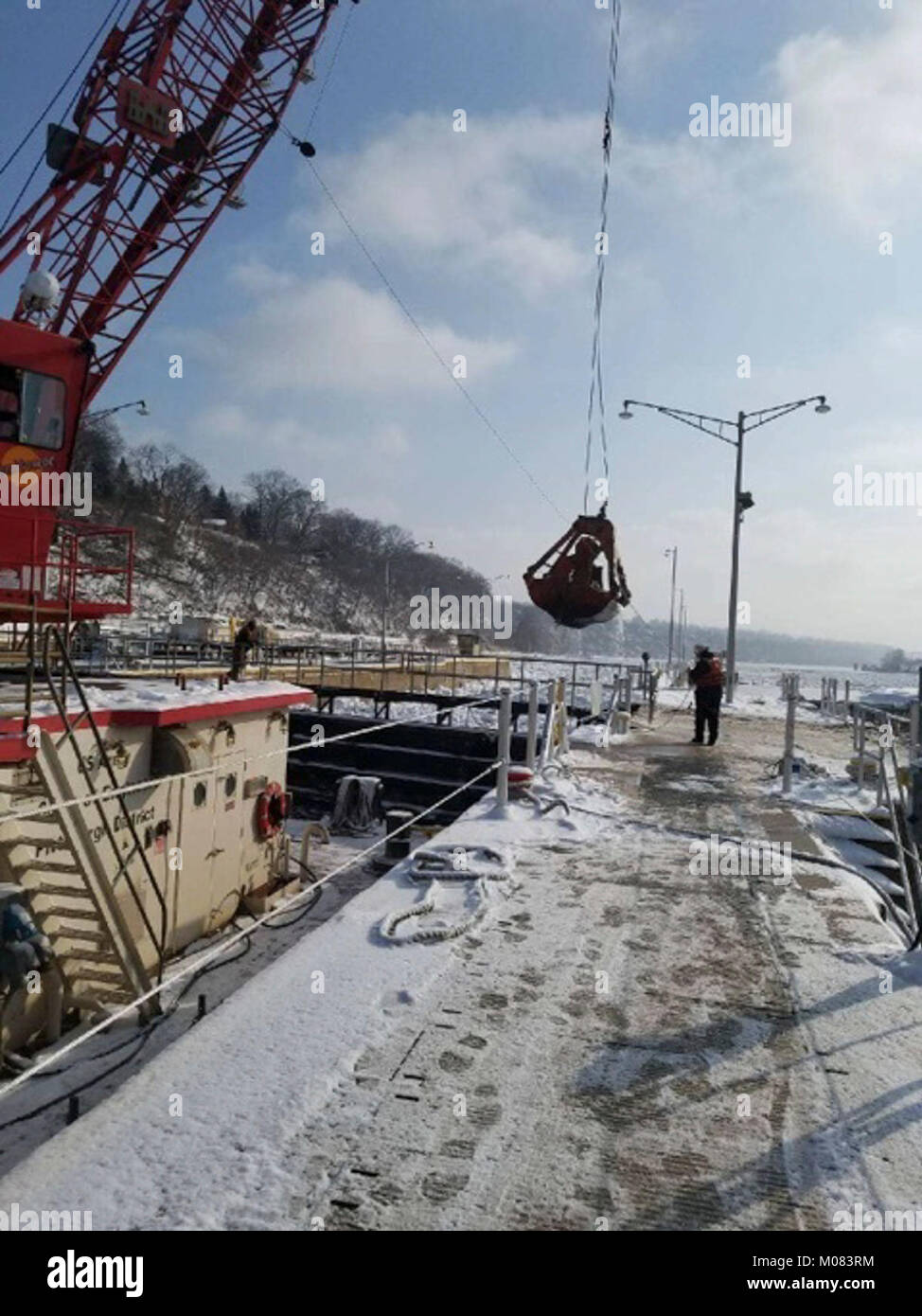 U.S. Army Corps of Engineers members conduct ice-breaking operations at ...