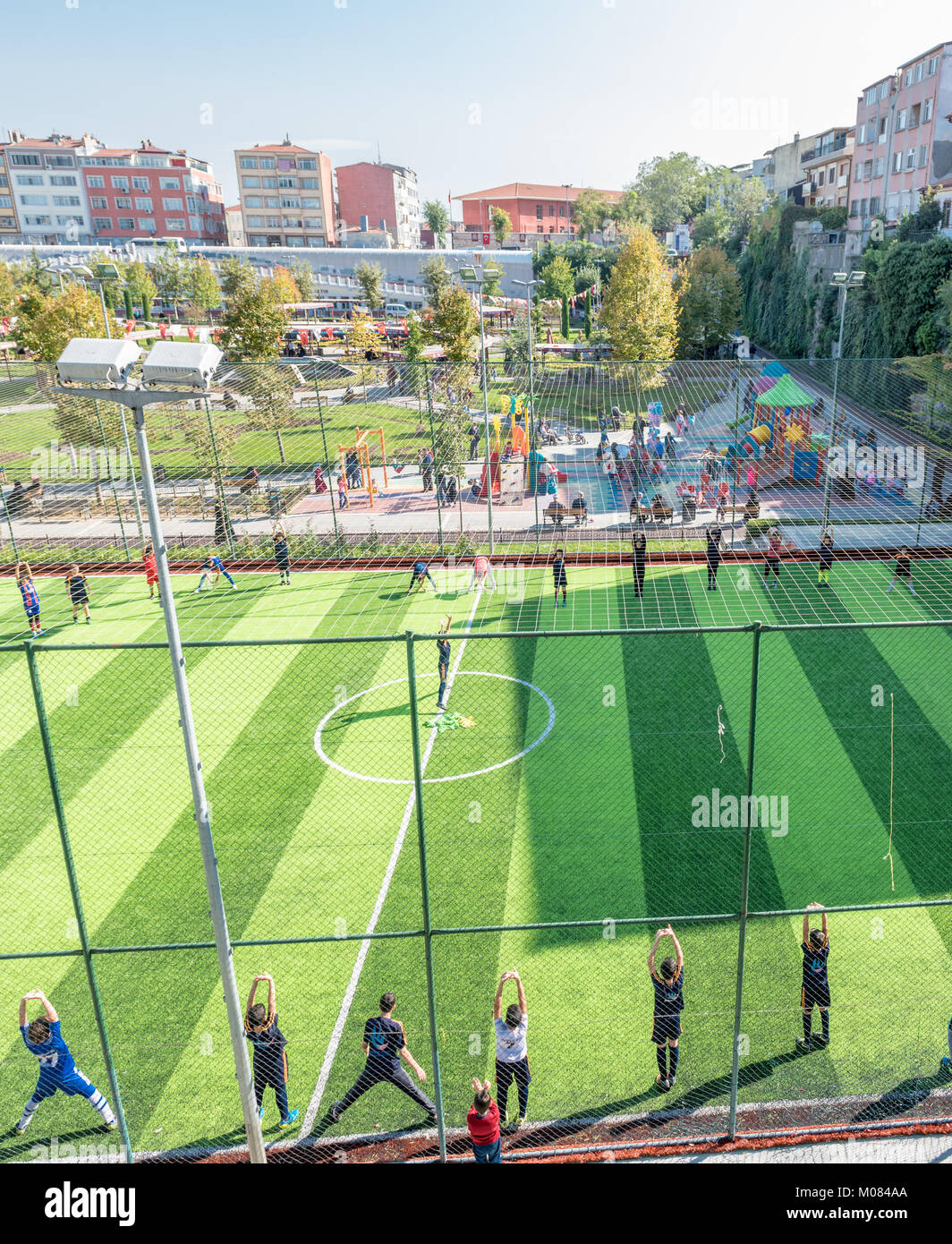 Unidentified Kids exercising before match on soccer field or football ...