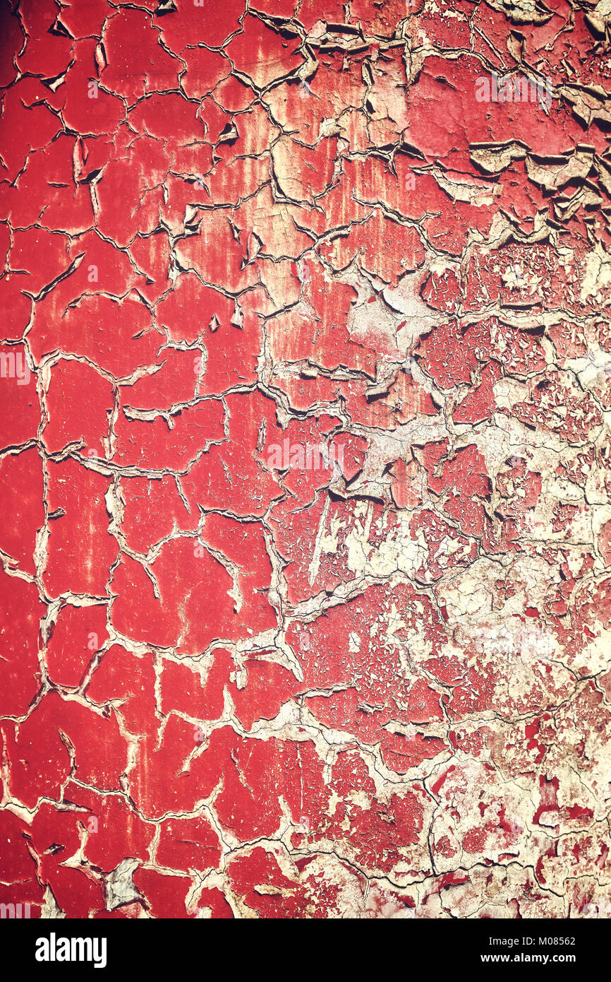Cracking and peeling paint on a wall, color toned background or texture ...