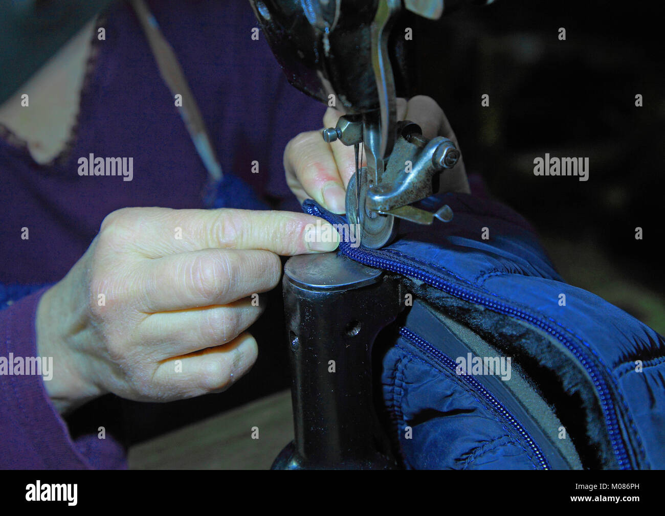 In the Shoe shop of female hands sew the lock on the boots on the ...