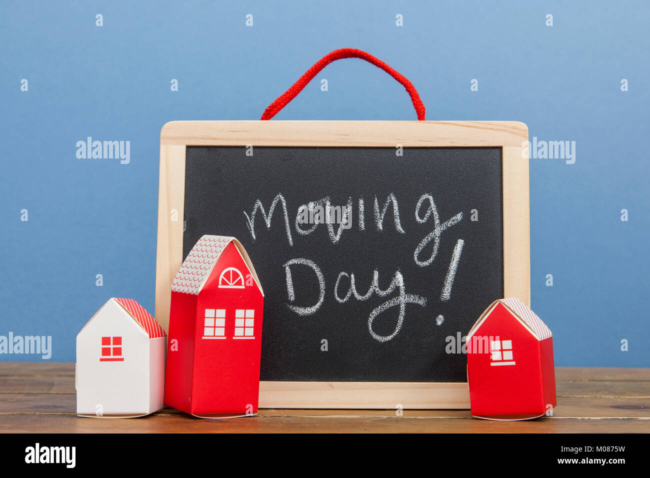Moving house concept. Small houses by a blackboard Stock Photo - Alamy