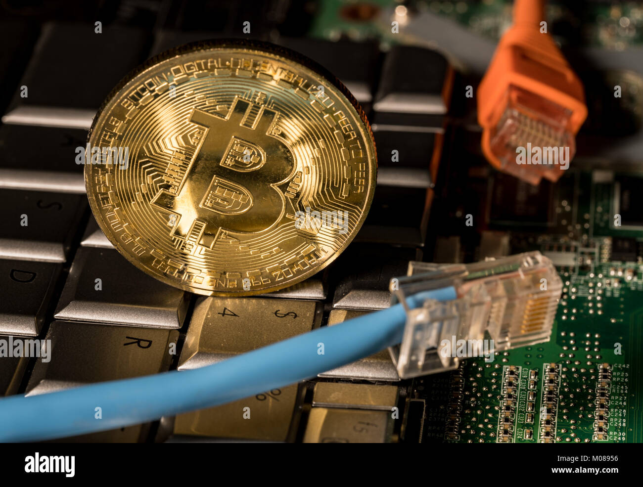 Bitcoin coin standing on keyboard of computer Stock Photo - Alamy