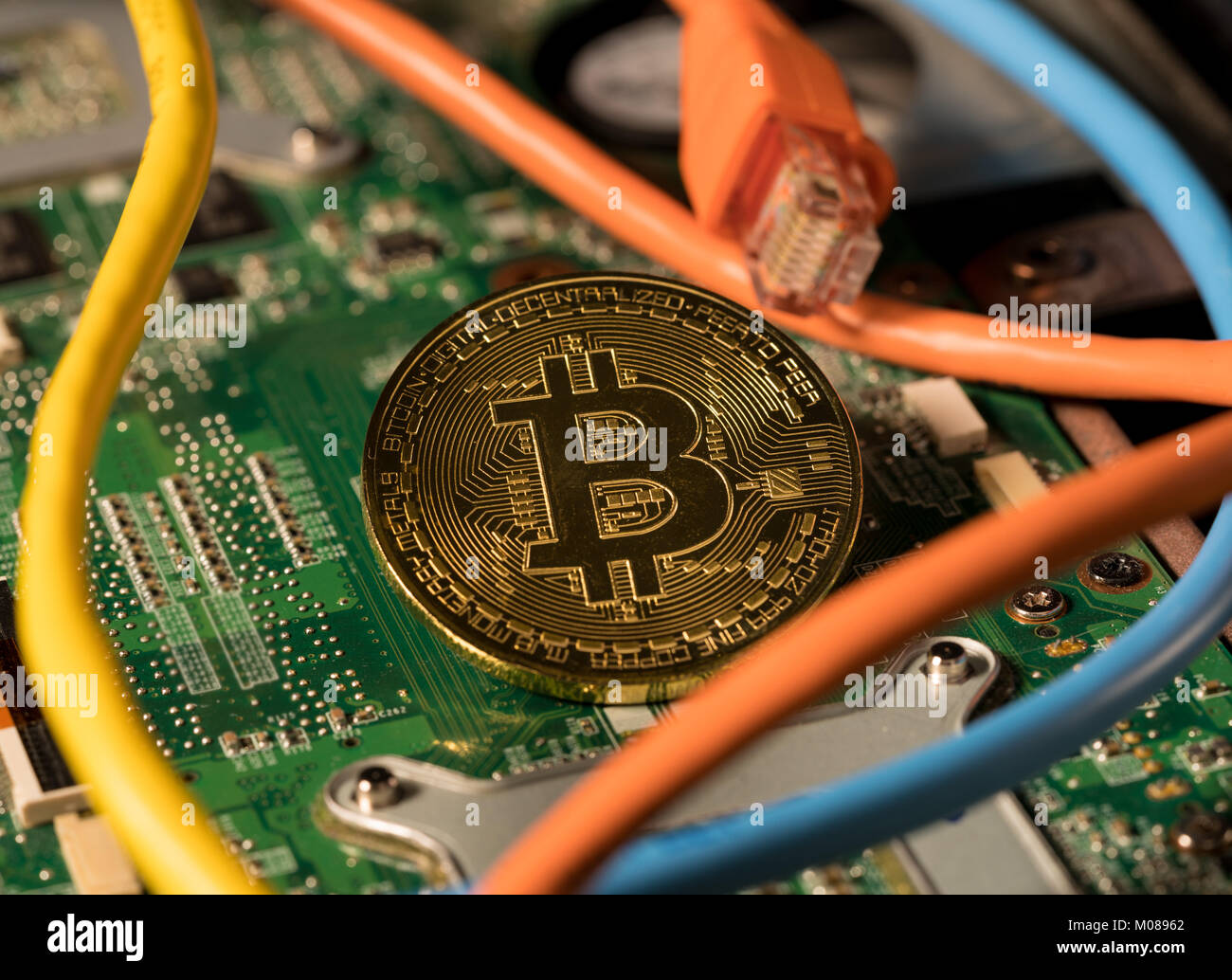 Bitcoin coin standing on motherboard of computer Stock Photo - Alamy