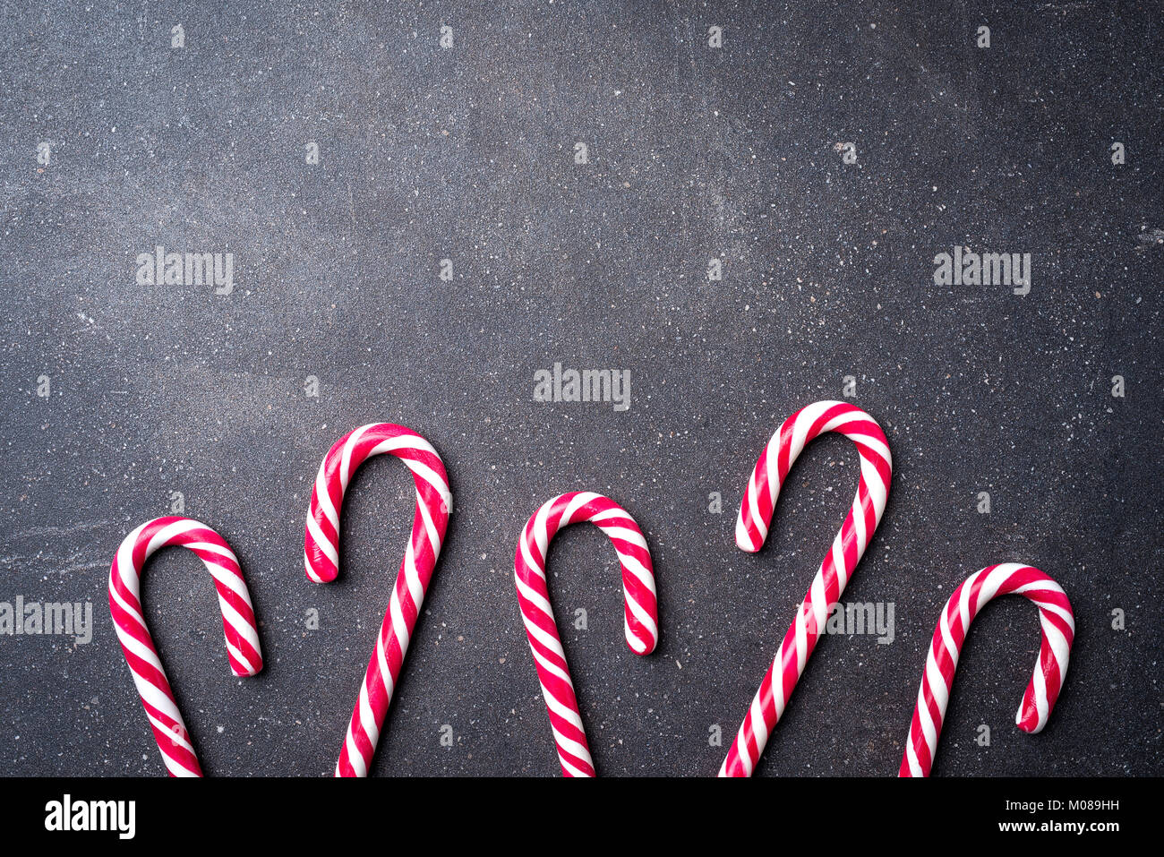 Candy canes on gray stone background. Close up Stock Photo - Alamy