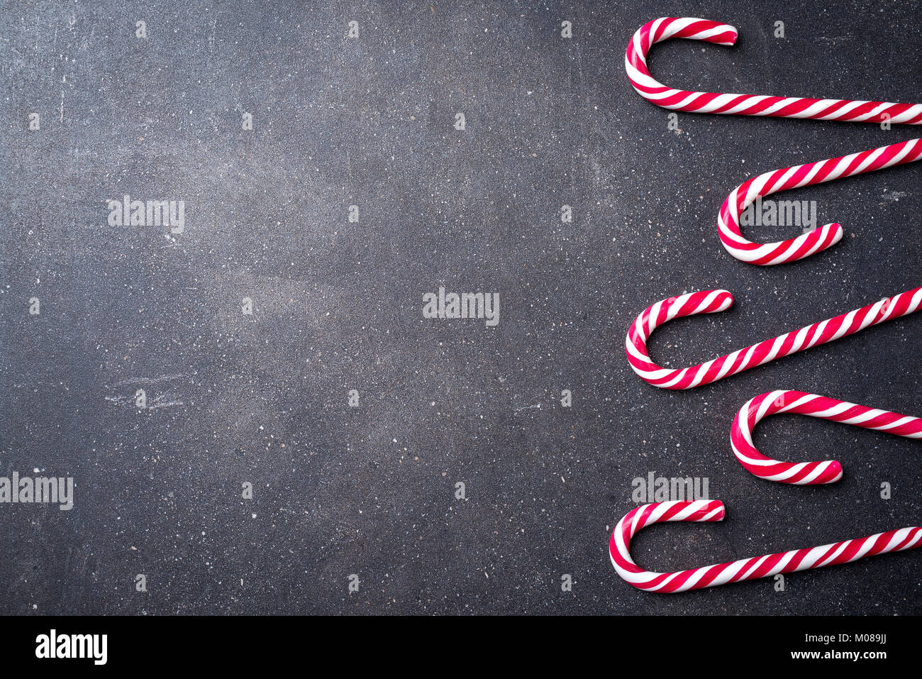 Candy canes on gray stone background. Close up Stock Photo - Alamy