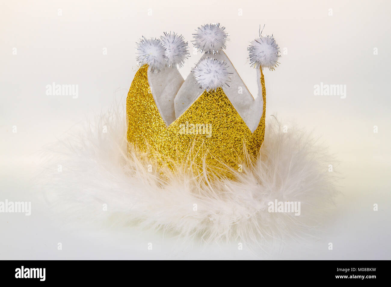 Funny crown with Feather on bright background Stock Photo - Alamy