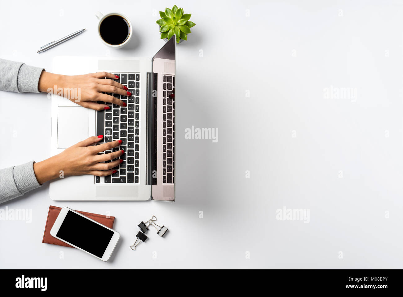 Female hands working on modern laptop. Office desktop on white ...