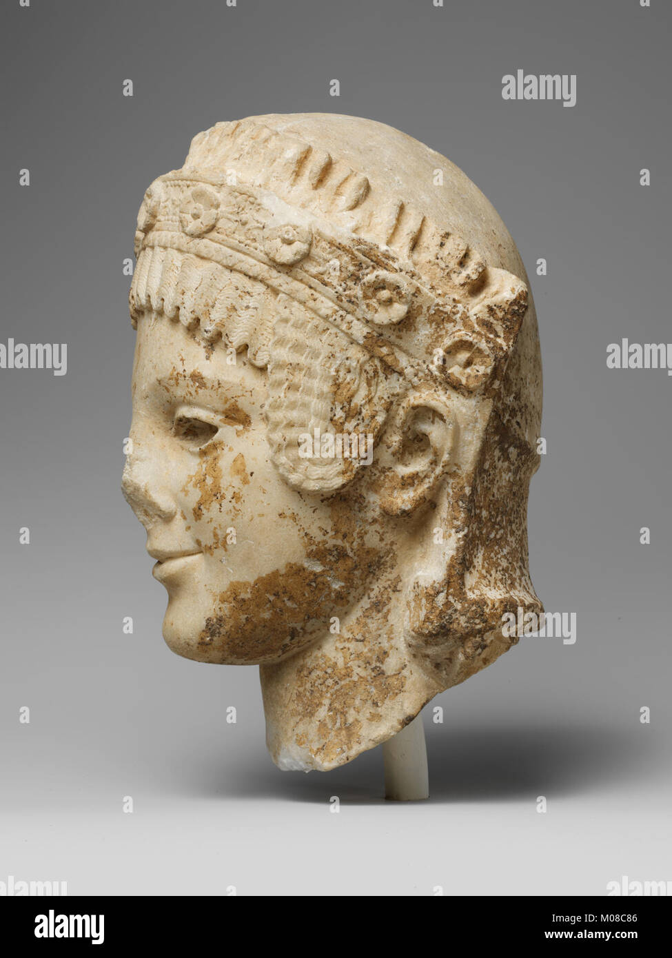 This marble head of Athena, a classical Greek sculpture, represents the ...