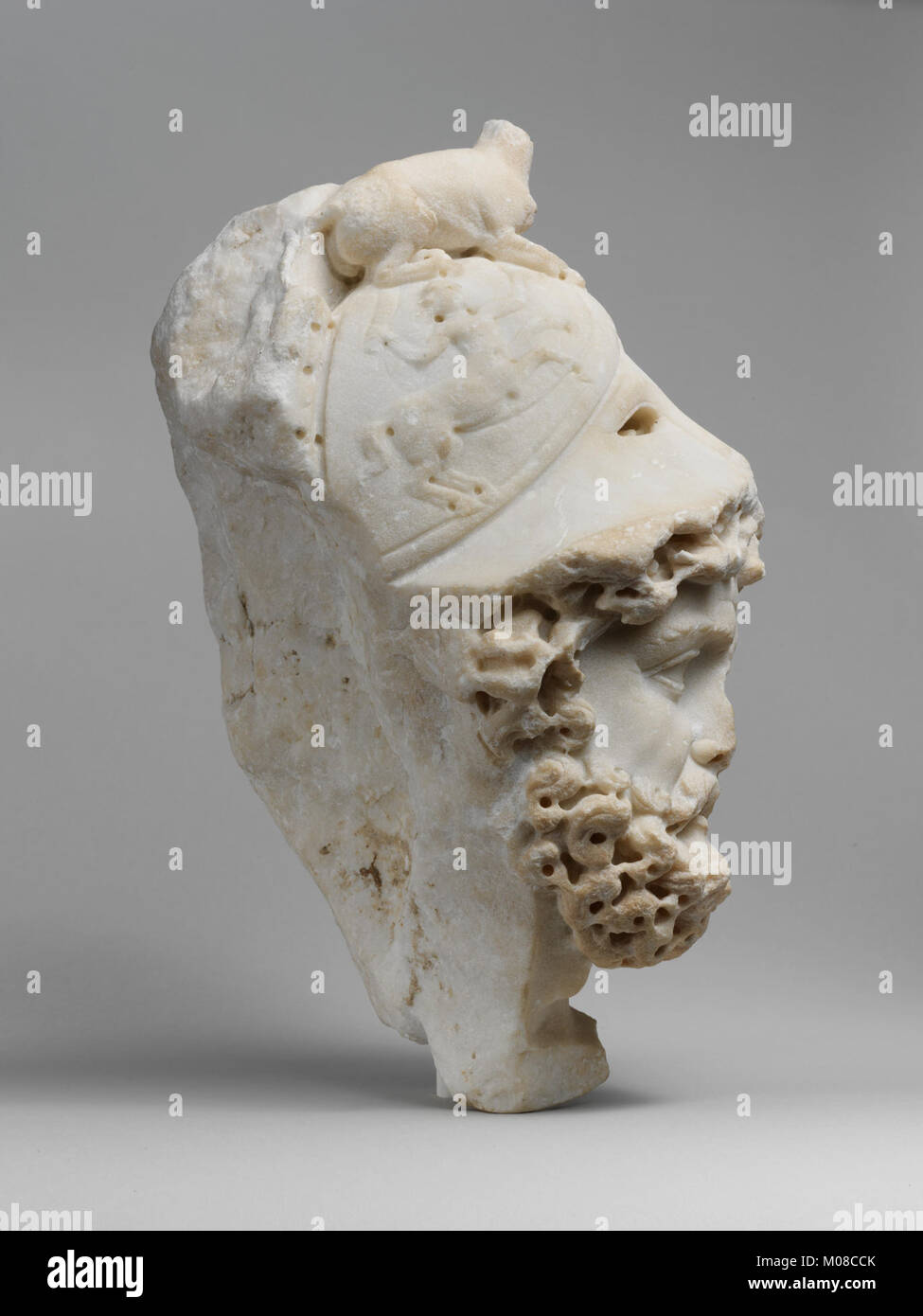 This marble relief fragment features the head of Mars, the Roman god of ...