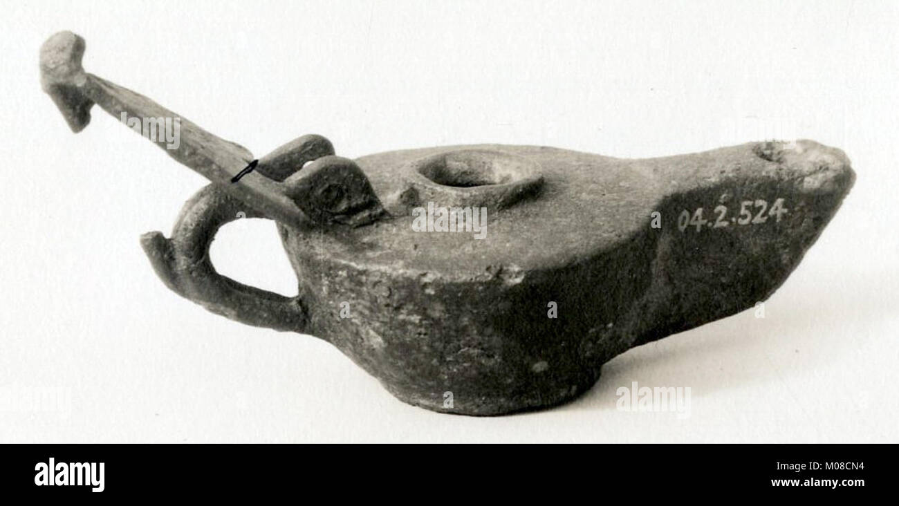This lamp is an ancient lighting device with a simple, functional ...