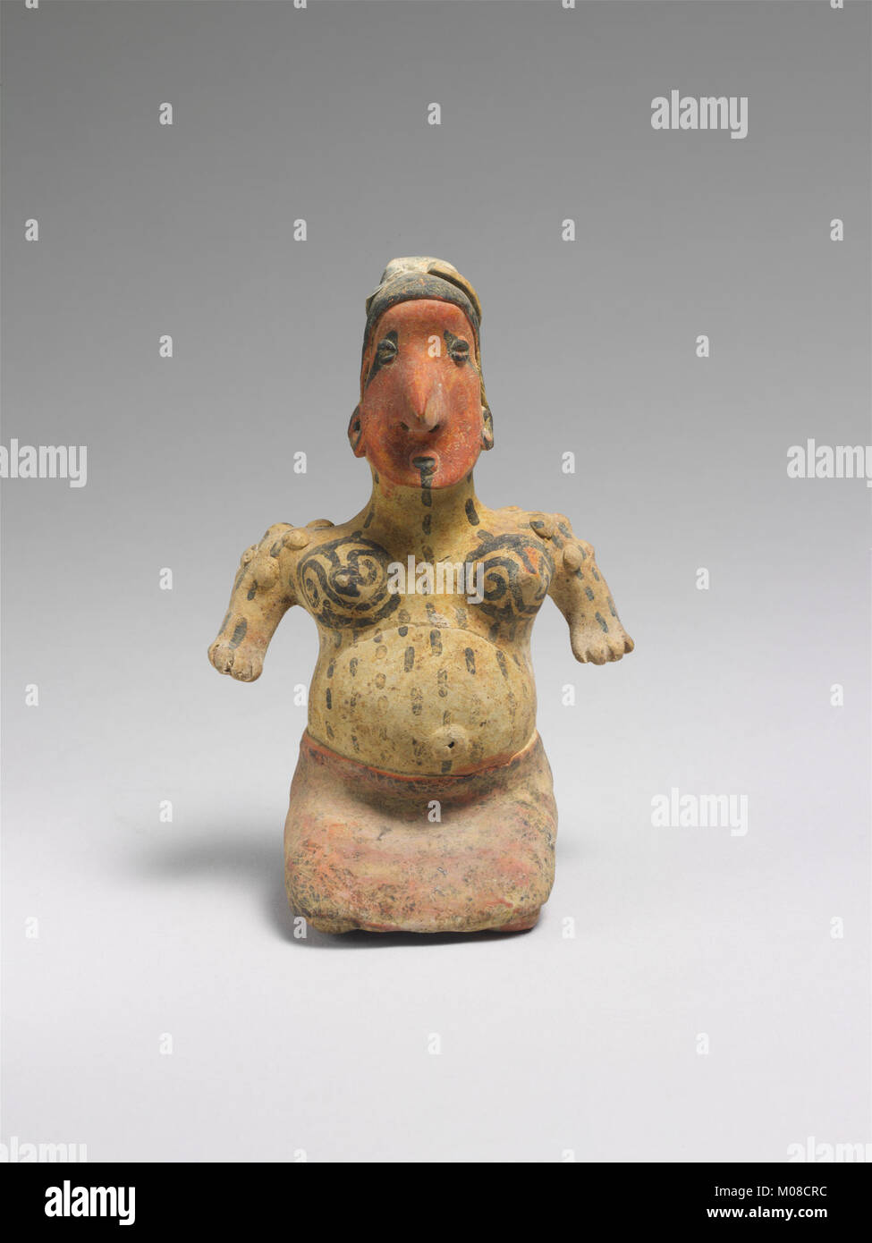 This sculpture depicts a kneeling female figure, captured in a moment ...