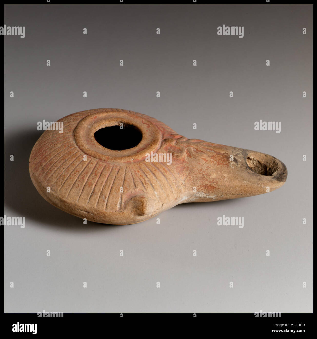 This ancient lamp demonstrates functional design, illumination, and ...