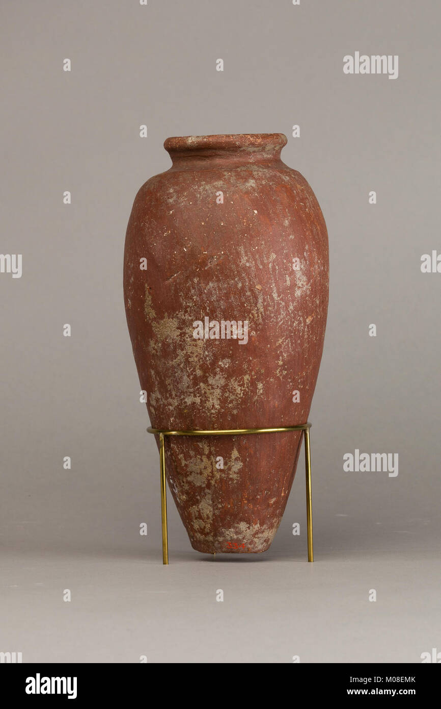 This large red polished ware jar, crafted from clay, reflects the ...