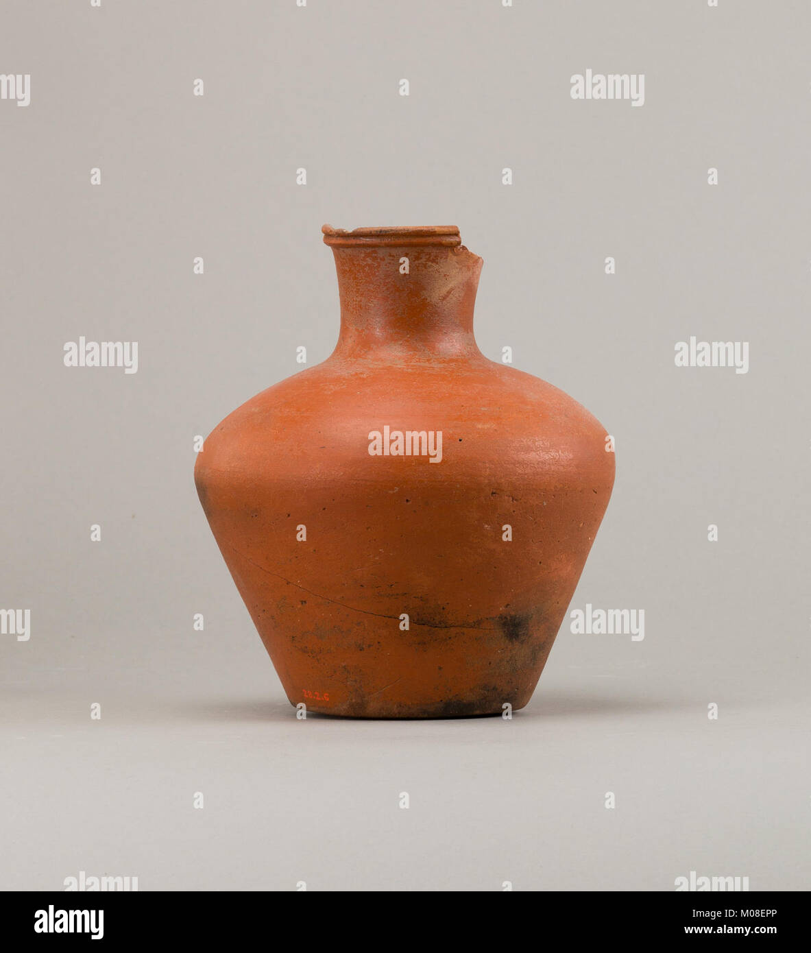 This jar, with its flat base, exemplifies ancient ceramic craftsmanship ...